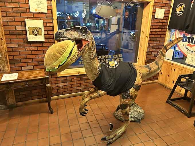 A life-sized velociraptor wearing an Eh! Burger shirt is either brilliant marketing or someone lost a very specific bet.