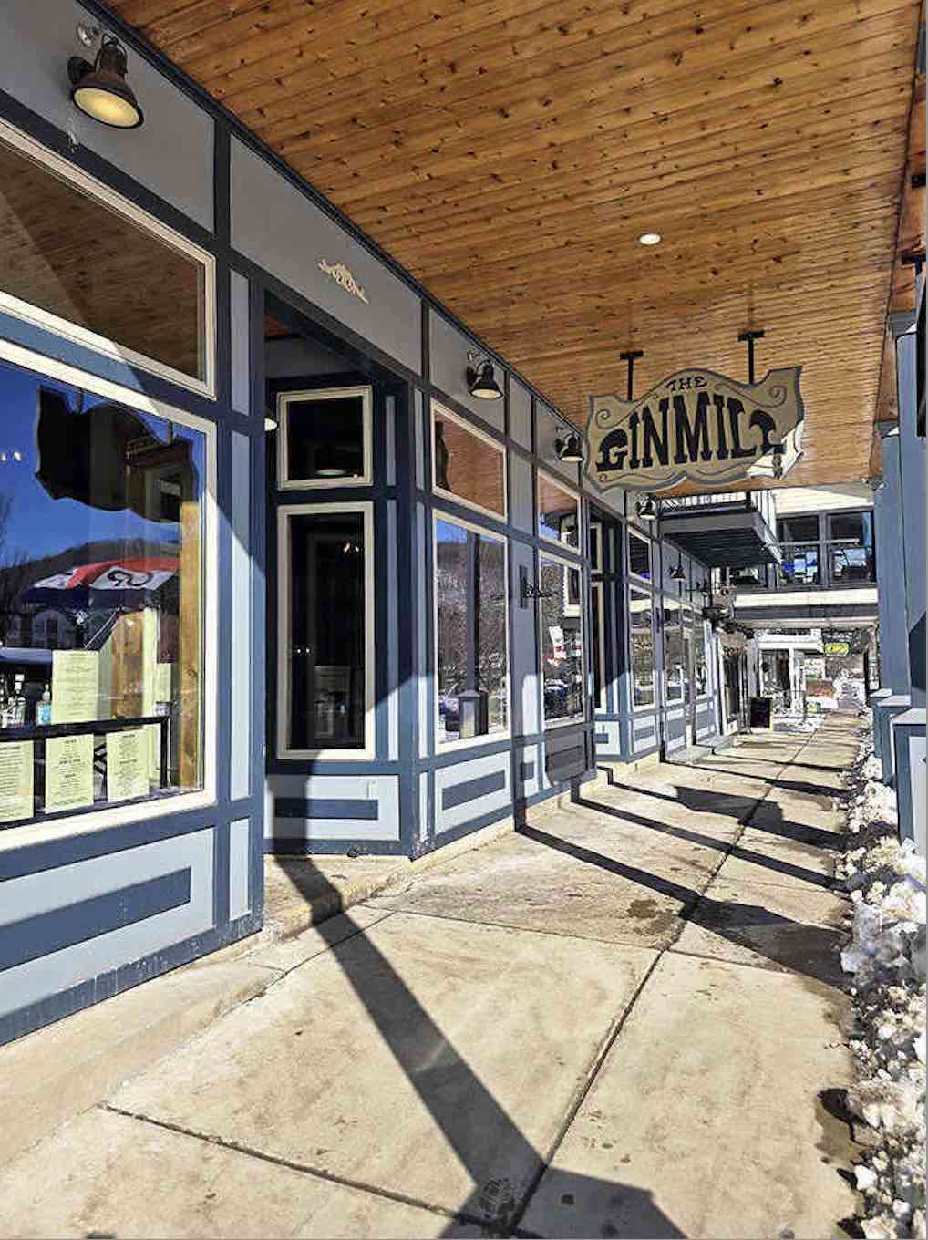 The Gin Mill's welcoming facade promises the kind of local hospitality that makes strangers feel like regulars immediately.