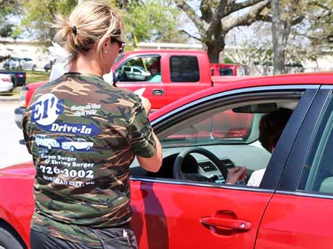 Carhop service keeping the classic drive-in tradition alive, one order delivered with a smile at a time.
