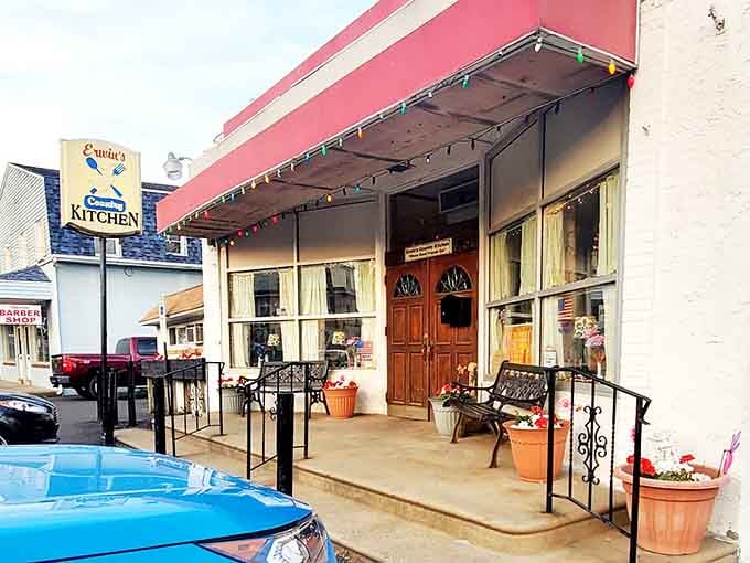 The welcoming entrance with its potted flowers and wooden doors invites you into something truly special inside.
