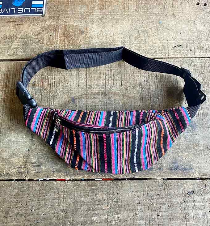 This multicolor woven fanny pack screams 1990s festival fashion and is absolutely making a comeback whether we're ready or not.