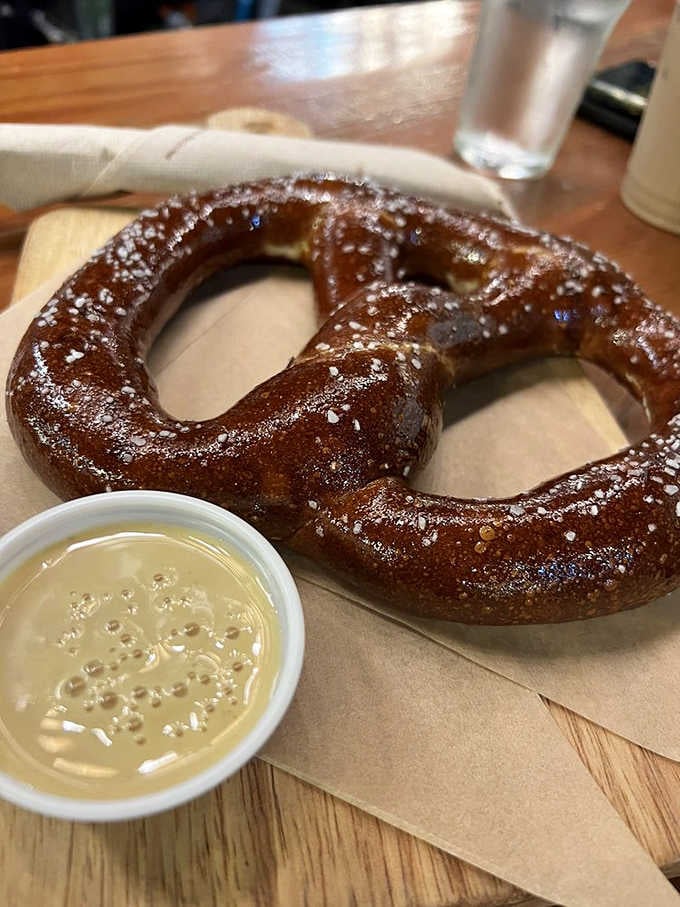A golden pretzel with mustard that's practically begging you to order another round while you're at it.
