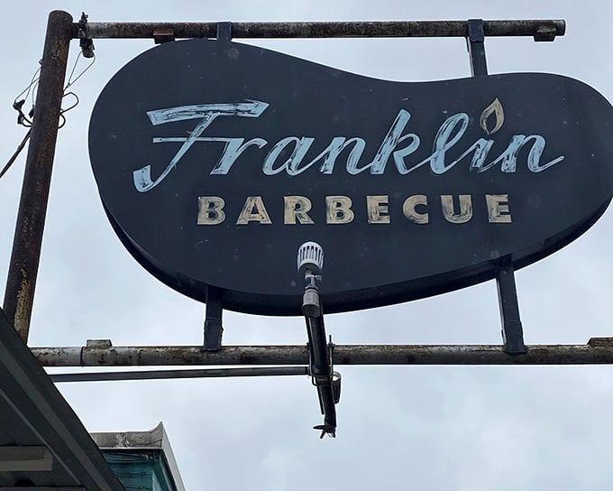 This weathered sign has guided more food pilgrimages than most GPS systems could ever hope to track.