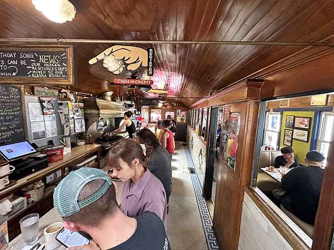 The bustling counter scene captures that authentic diner energy where strangers become friends over coffee and shared counter space.