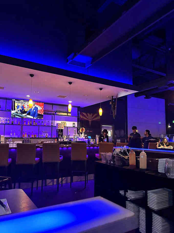 The bar area glows invitingly, offering liquid refreshments for those who've earned them through dedicated grilling and eating.