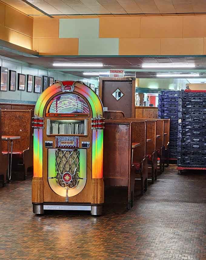 A genuine vintage jukebox standing guard, ready to soundtrack your meal with tunes that match the timeless atmosphere perfectly.