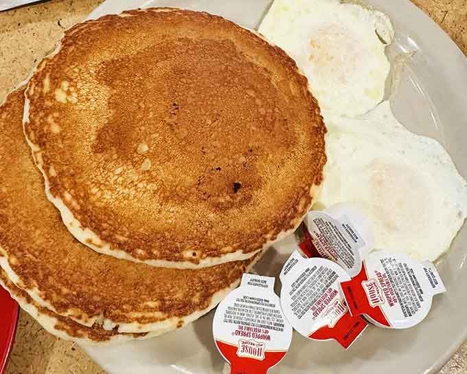 Pancakes the size of dinner plates with eggs and hash browns: breakfast that understands the assignment and aces the final exam.