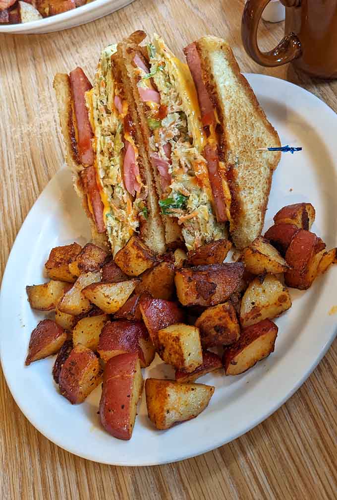 The double-decker Spamwich is unapologetically retro, stacked high with crispy potatoes and zero shame about its ingredients.