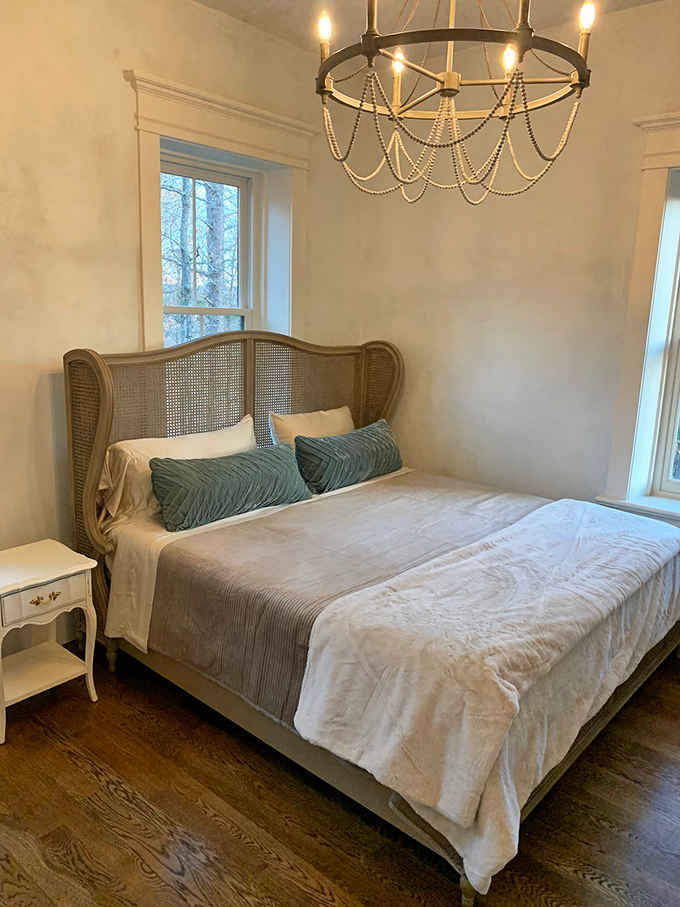 Cane headboards and elegant chandeliers prove that sleeping like royalty doesn't require an actual royal bloodline after all.