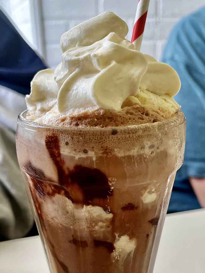 Swirls of chocolate and vanilla soft-serve towering like a delicious Leaning Tower of Pisa in a glass.