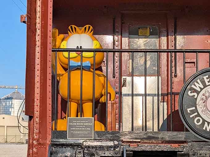 College-bound Garfield contemplates higher education while clutching a book he'll probably never actually open or read.