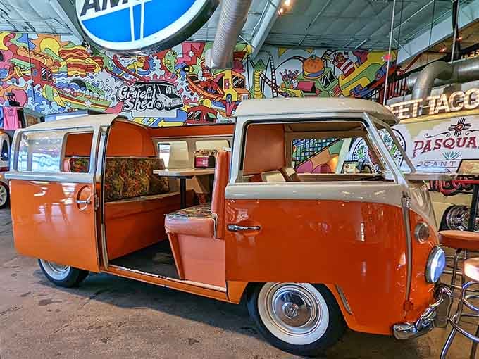 An orange retro van converted into dining booth seating makes you wonder why all restaurants aren't this fun.