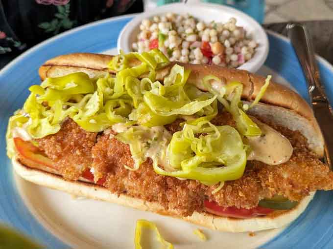Crispy catfish po' boy piled high with peppers, making Louisiana jealous one sandwich at a time here.