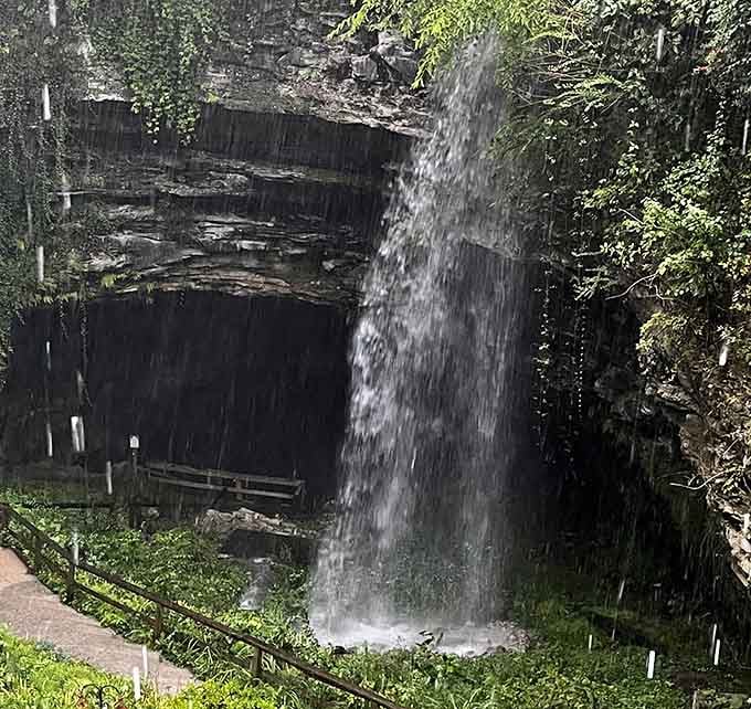 A waterfall cascading into the cave entrance, because nature loves making dramatic entrances as much as exits.