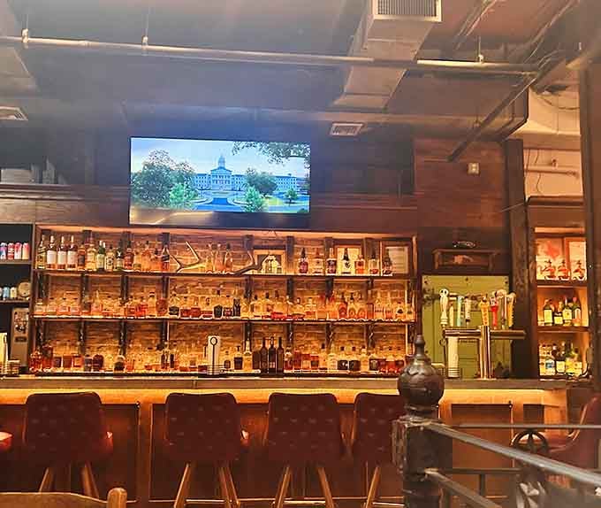 The bar showcases enough whiskey to make a Texan weep with joy, all backlit like liquid gold treasure.