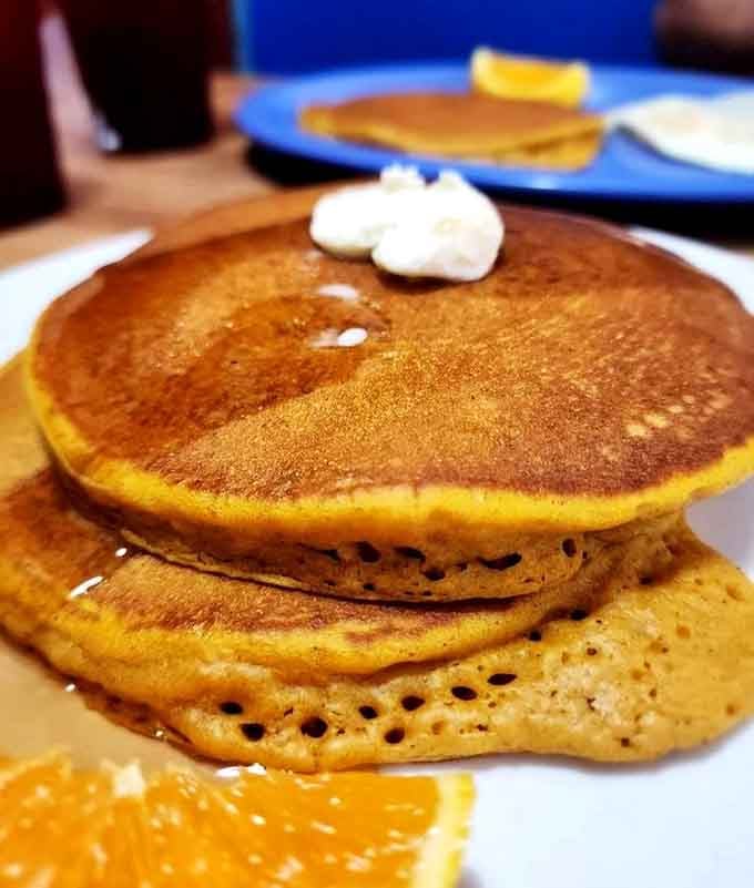 Pancakes stacked like edible architecture, golden and fluffy enough to inspire breakfast poetry.