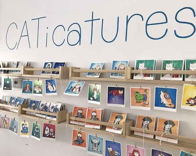 Whimsical cat portraits line the shelves, reminding us that art doesn't always have to be serious business.