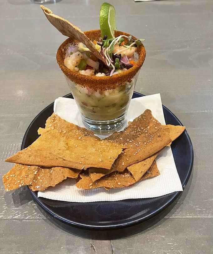 Shrimp ceviche served in a glass with crispy accompaniments, because presentation matters when you're eating something this photogenic.