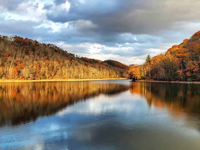 Fall foliage reflected in mirror-still water creates the kind of beauty that cameras can barely capture adequately.