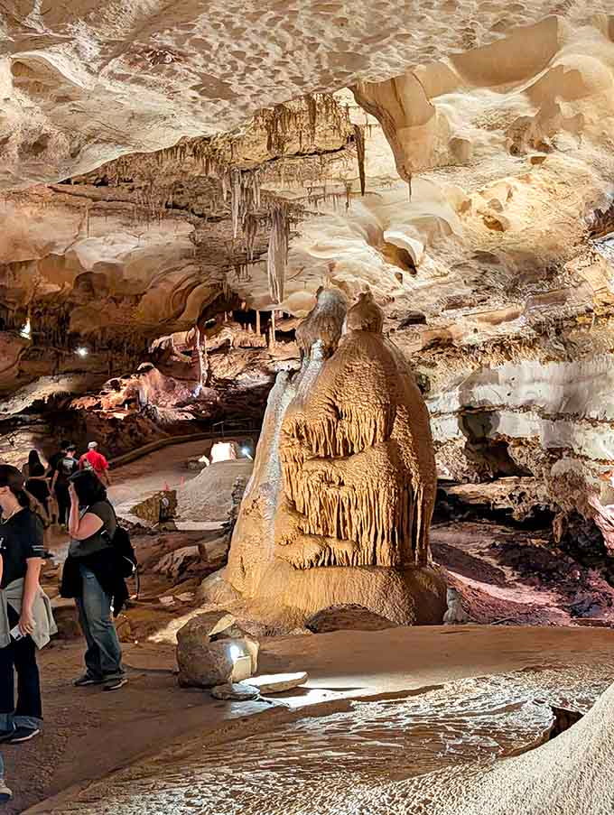 The massive stalagmite rises from ancient pools, a testament to water's patient, persistent artistry over millennia.