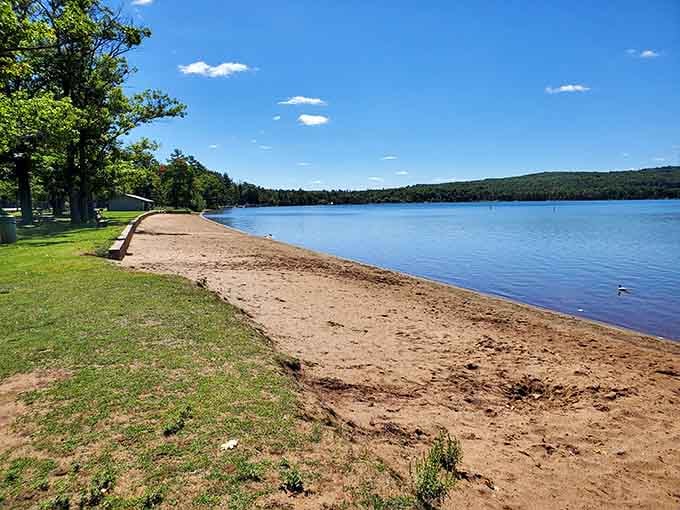 Lake Antoine Park's beach stretches out like nature's invitation to forget your phone exists for awhile.
