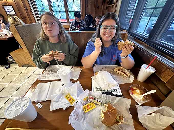 The smiles say it all: this is what happiness looks like when it comes with fries and shakes.