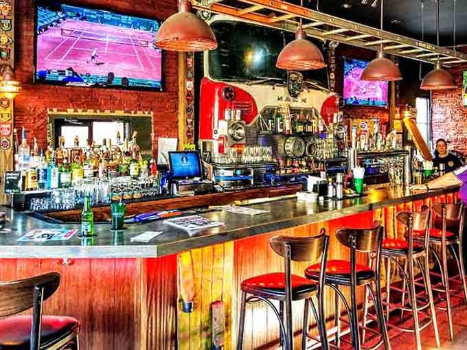 The bar gleams with copper accents and promise, inviting you to settle in for the long haul.