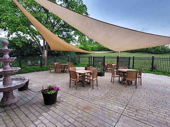 Outdoor patio seating under shade sails, perfect for warm evenings when you want history with fresh air included.