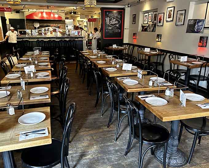 Clean tables set and waiting like a stage before the curtain rises on tonight's delicious performance.