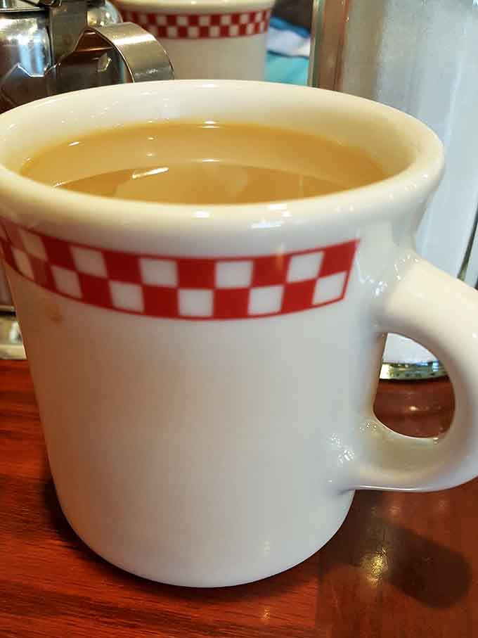 That checkered mug holds liquid motivation, the kind of coffee that's fueled Staunton mornings for longer than smartphones have existed.