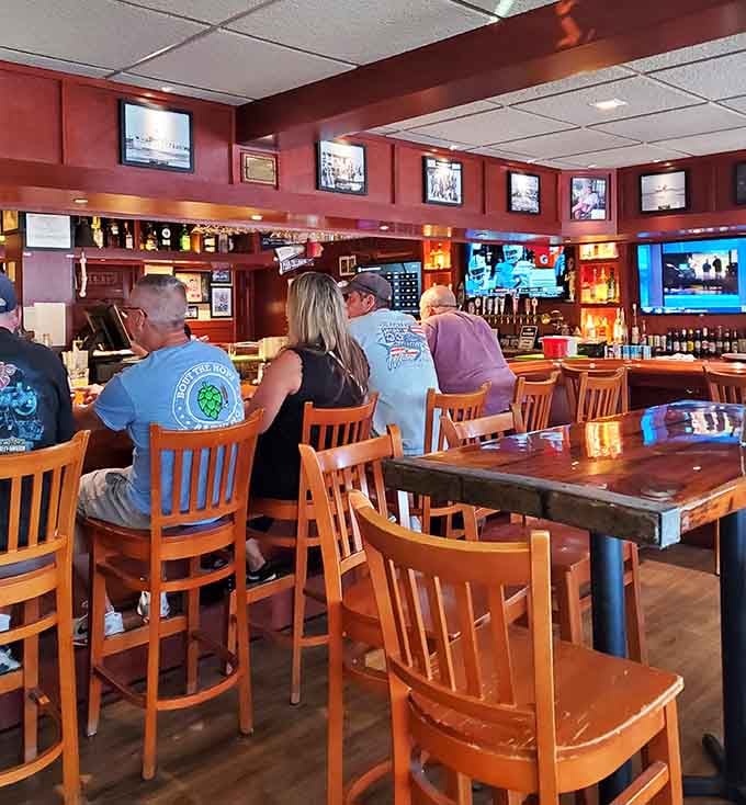 The bar area buzzes with conversation and camaraderie, where locals and visitors alike gather for cold drinks and warm hospitality year-round.