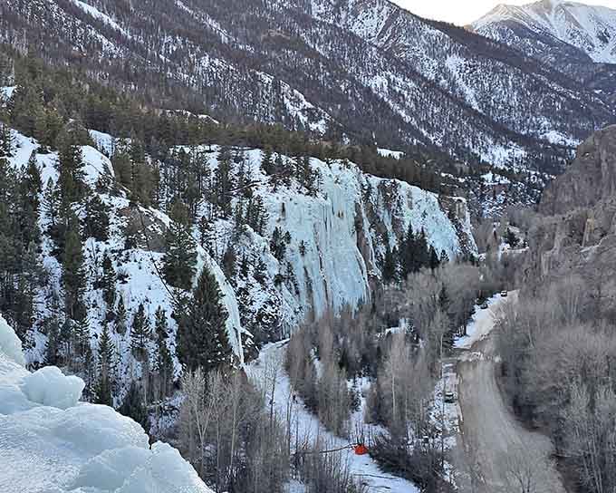 Frozen waterfalls cascade down the cliffs in crystalline columns that would make Elsa from Frozen genuinely jealous of nature's artistry.