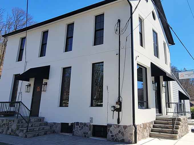 Crisp white walls and black awnings create classic elegance, the kind of timeless style that never goes out of fashion.
