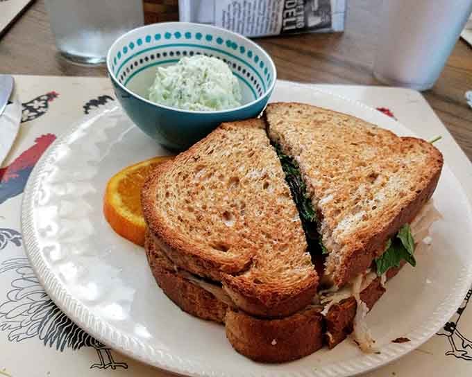 That perfectly toasted sandwich with coleslaw proves lunch here is just as impressive as the tea service.
