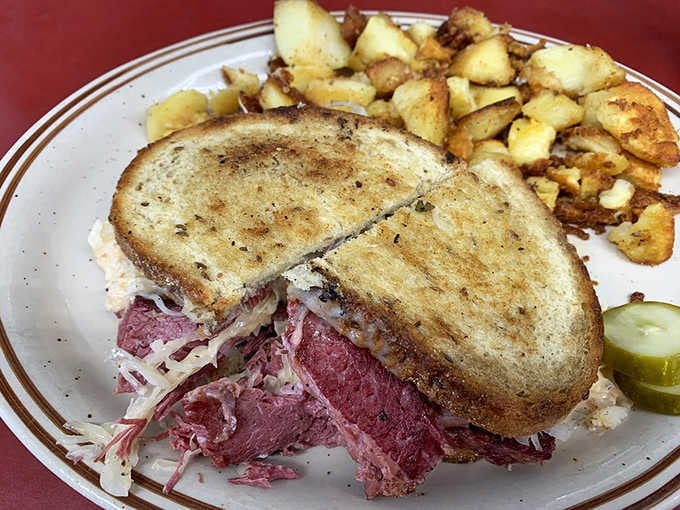 A Reuben sandwich stuffed with corned beef and sauerkraut, grilled until the cheese surrenders completely to heat.