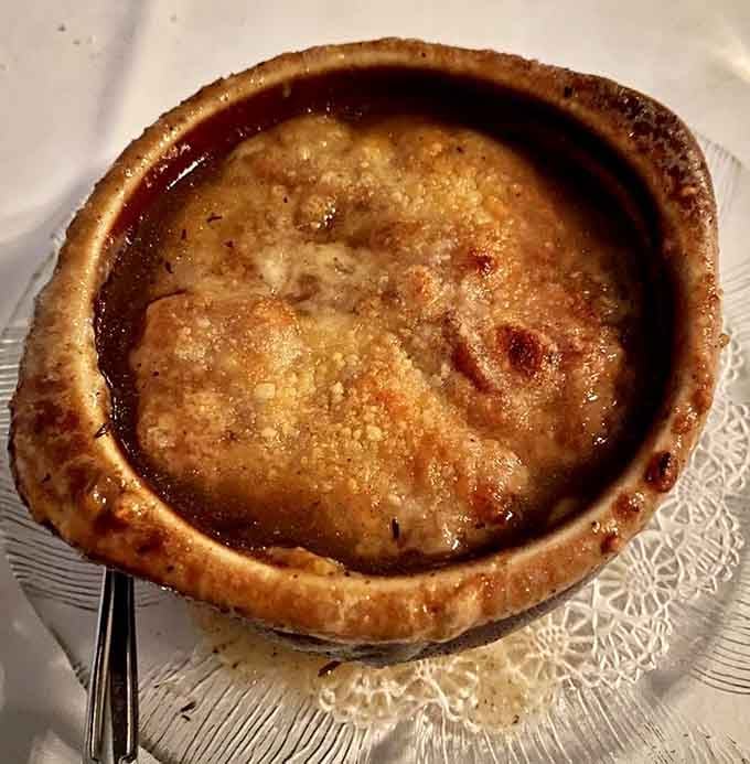 French onion soup arrives bubbling hot with a cheese crust that could stop traffic on DeMenil Place.