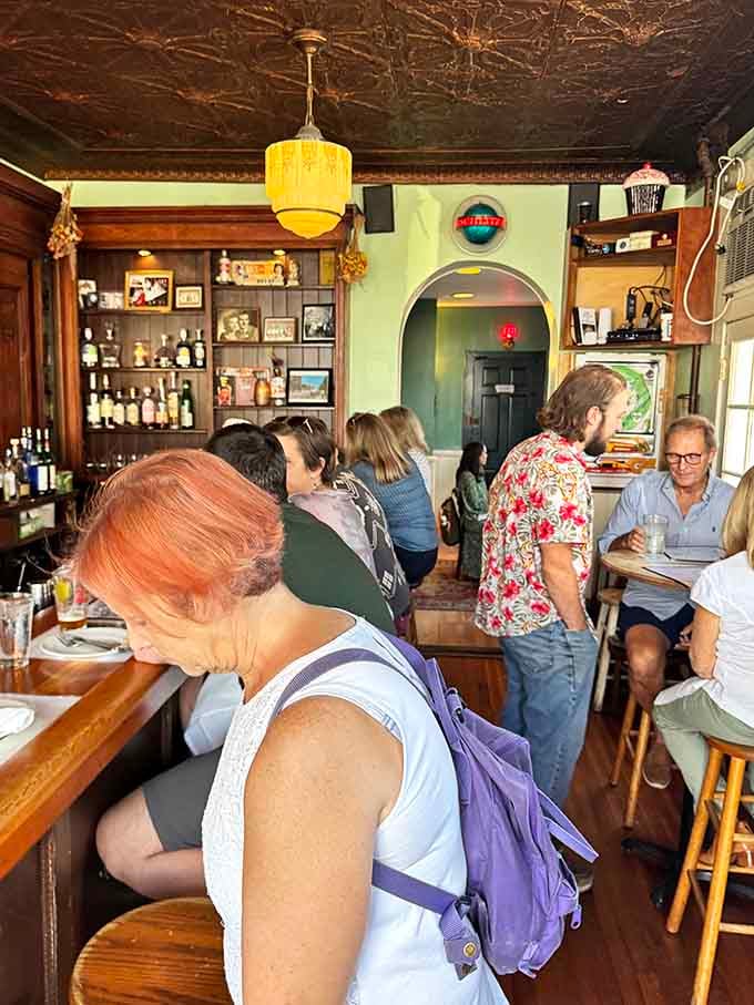 The ornate tin ceiling and vintage light fixtures transport you to an era when dining out meant something special, not just fuel.
