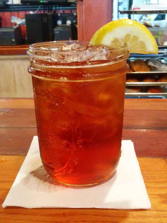 Sweet tea served proper in a mason jar with lemon, refreshing enough to make you forget it's humid.