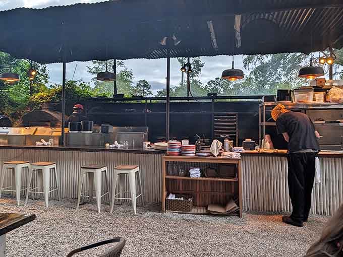 Watching the kitchen work over open flames reminds you that cooking is both ancient art and modern entertainment combined.