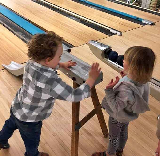 Future bowling legends learning that the best entertainment doesn't require batteries, just a ball and some enthusiasm.
