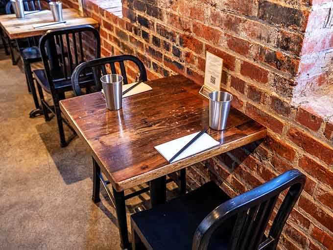 Rustic wooden tables against exposed brick create the perfect backdrop for sharing dishes and making food memories.