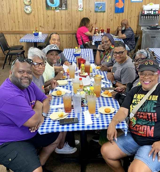 Happy diners gathered around checkered tablecloths prove that great food brings people together better than any social media algorithm ever could.