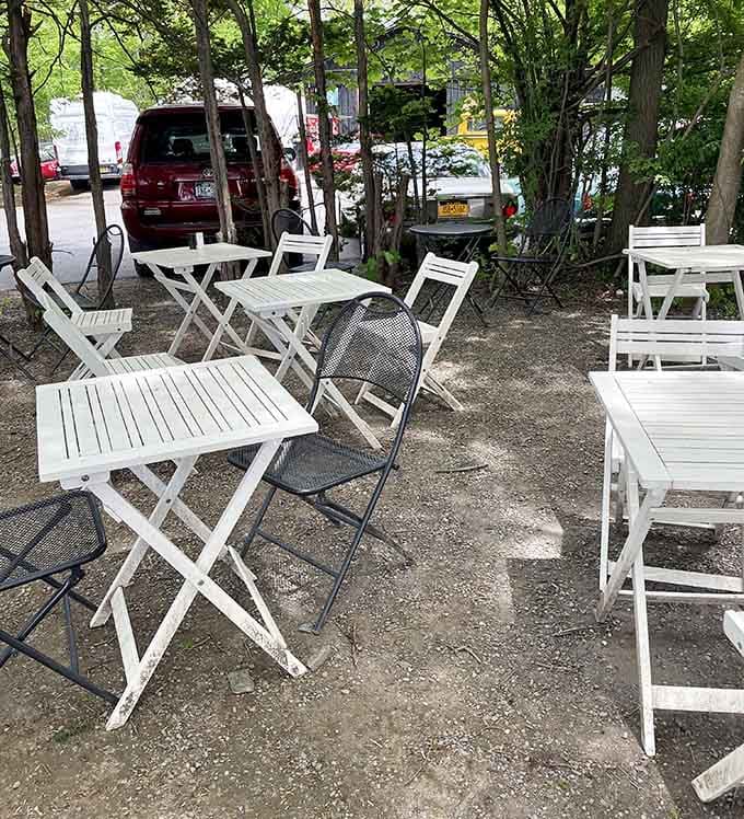 White tables under the trees where you can enjoy your meal while pretending you're on vacation.