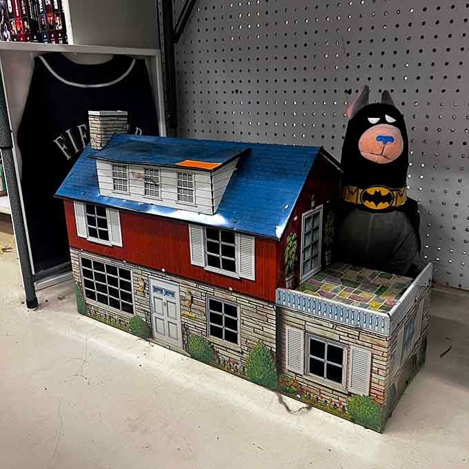 A vintage dollhouse guarded by Batman, because even superheroes appreciate quality mid-century American toy craftsmanship.