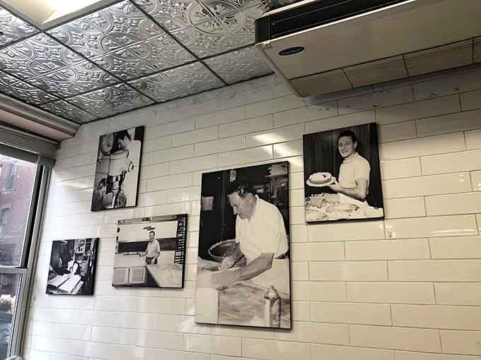 Vintage photographs on the walls tell stories of decades past, when these same pastries made earlier generations just as happy.