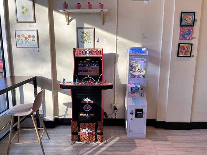 A vintage NBA Jam arcade game stands ready to entertain while you wait, because nostalgia pairs perfectly with donuts.