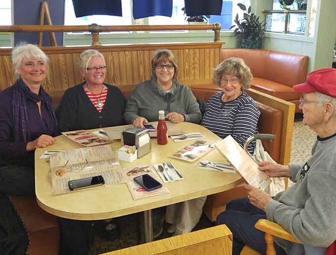 Regular customers gathering around a booth, sharing stories and meals&mdash;this is what community dining looks like in its purest form.