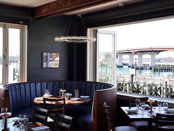 Cozy booth seating with dramatic lighting creates the perfect spot for lingering over multiple courses and good conversation.