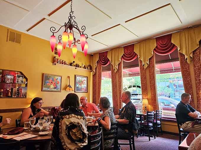 Happy diners enjoying their meals under cheerful chandeliers, living their best Eastern European culinary adventure right now.