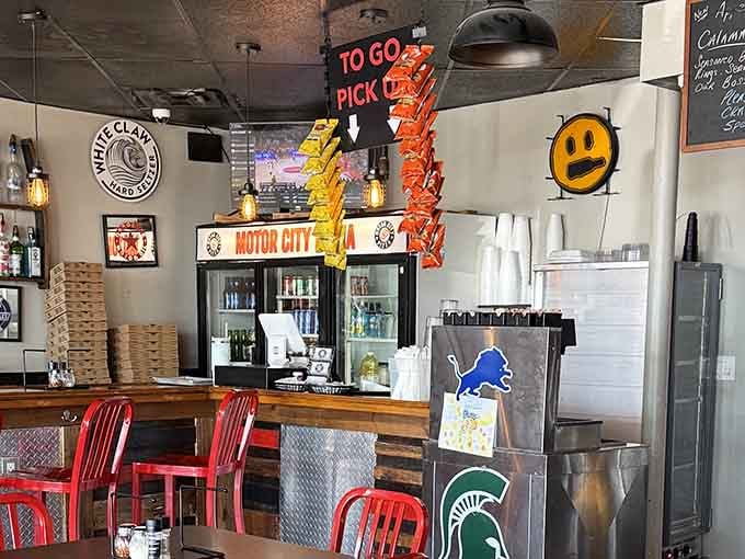 The pickup counter where dreams become reality and those rectangular boxes hold edible treasures worth the wait.